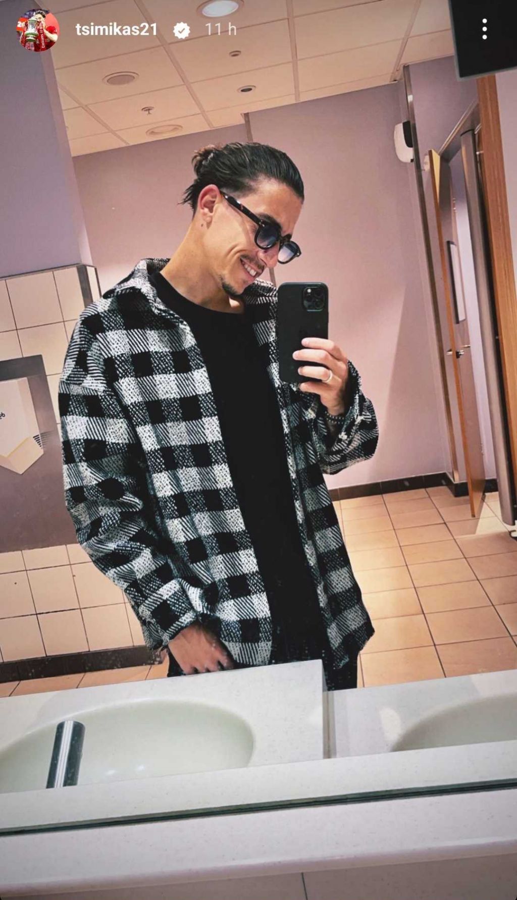 Kostas Tsimikas poses with a new hairstyle ahead of international break